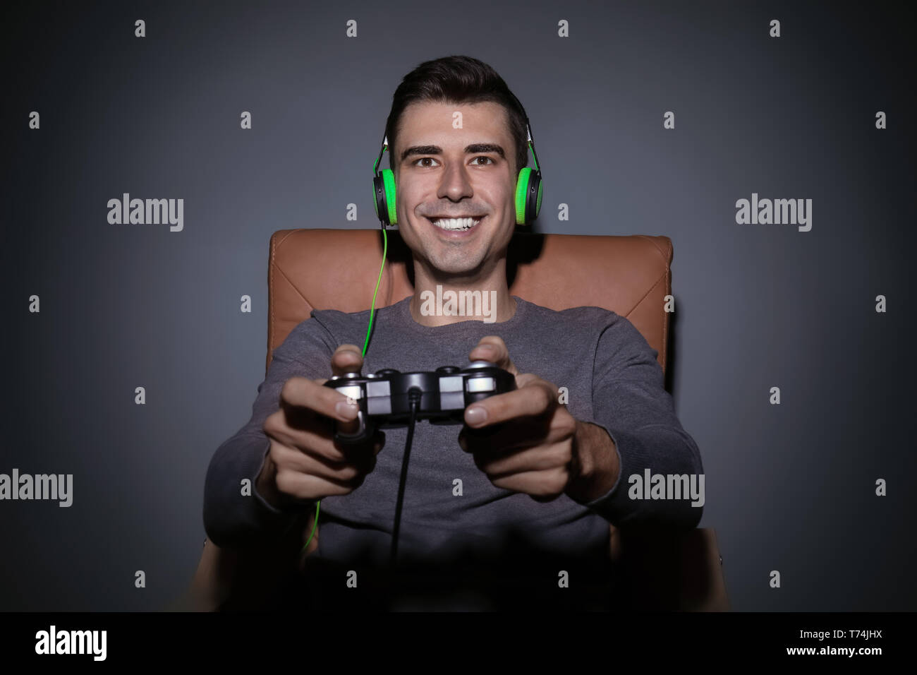 Young man playing video game at home in the evening Stock Photo - Alamy