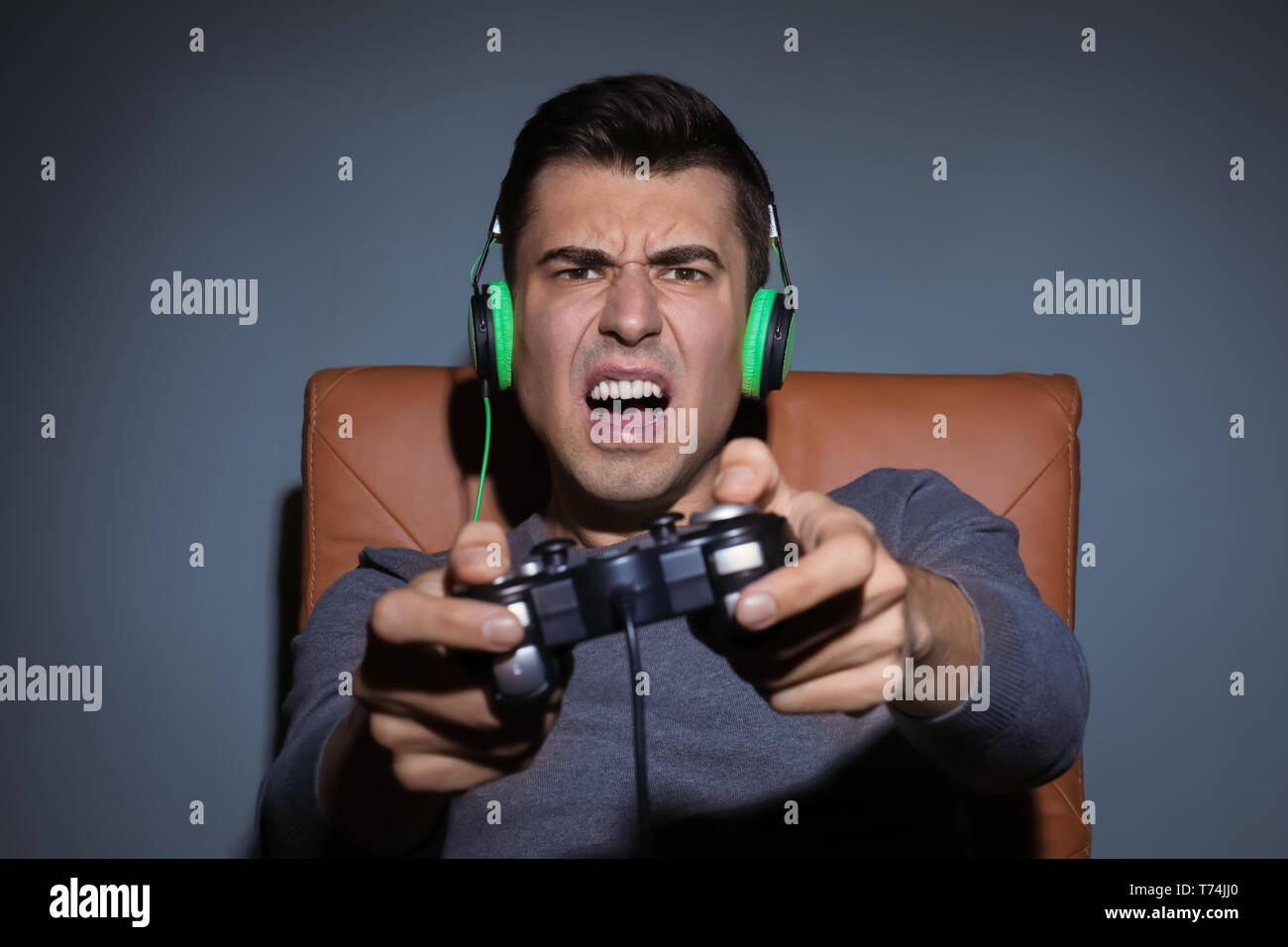 Young man playing video game at home in the evening Stock Photo - Alamy