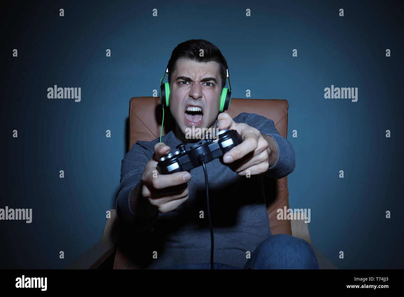 Young man playing video game at home in the evening Stock Photo - Alamy