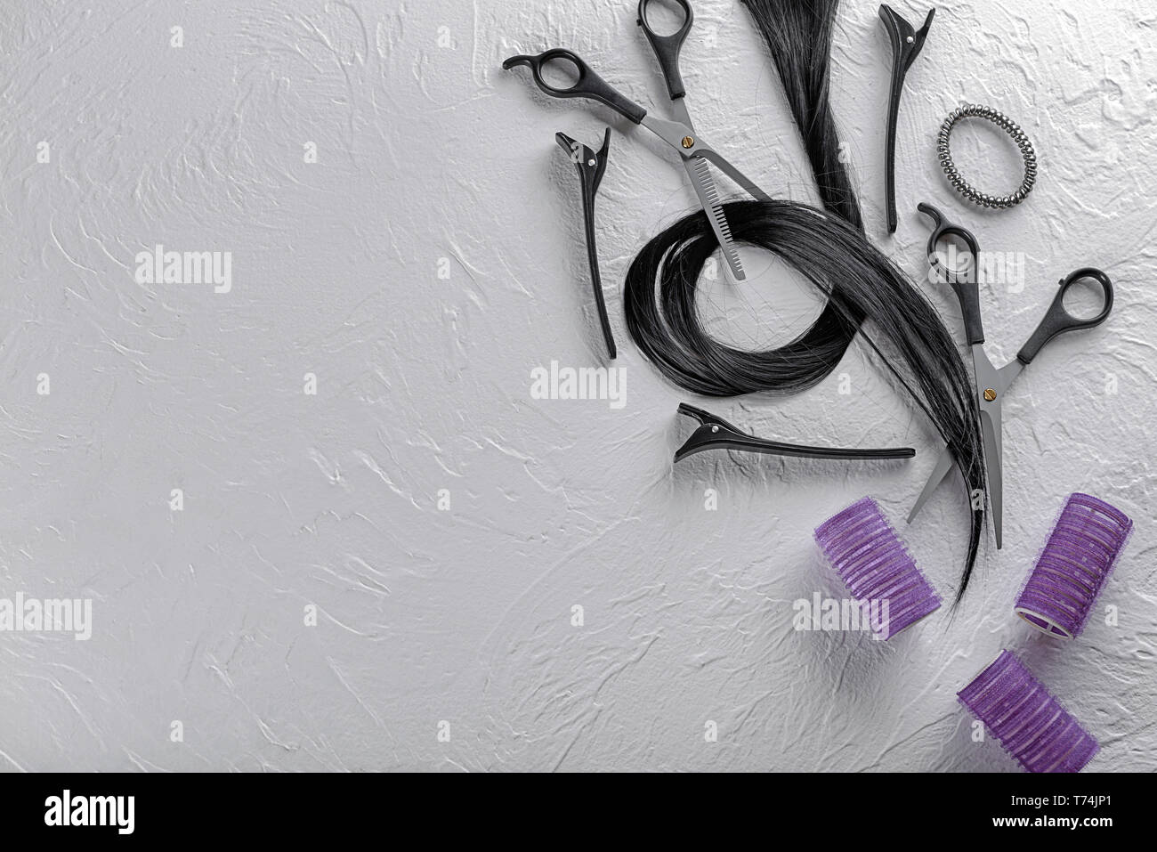 Professional hairdresser's tools and strand of hair on white textured ...