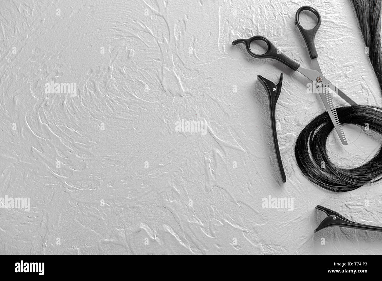 Professional hairdresser's tools and strand of hair on white textured ...