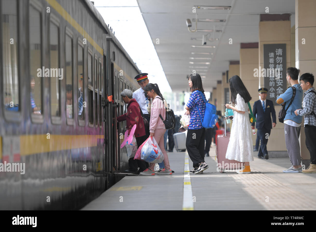 Changsha. 4th May, 2019. Passengers board the train at Changsha railway ...