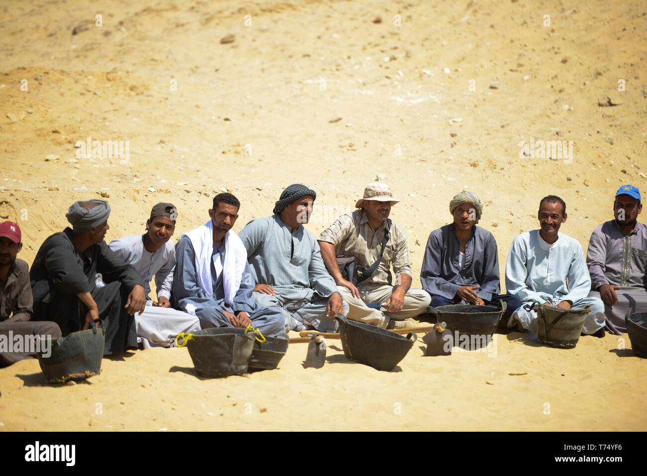 Giza, Egypt. 04th May, 2019. Egyptian workers sit near a newly ...