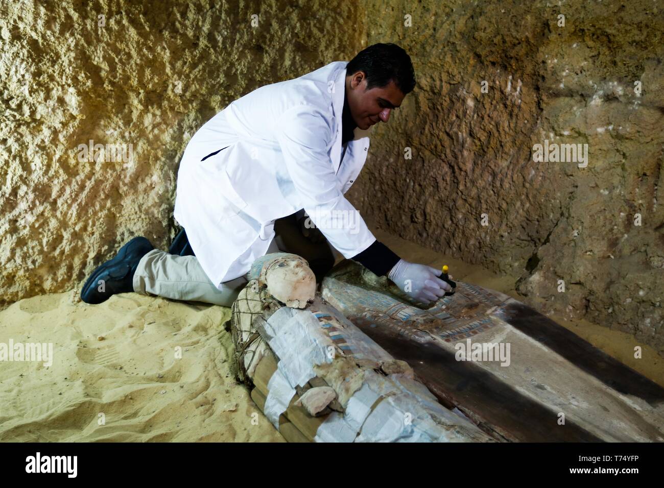 Giza, Egypt. 04th May, 2019. An Egyptian archaeological expert works on ...