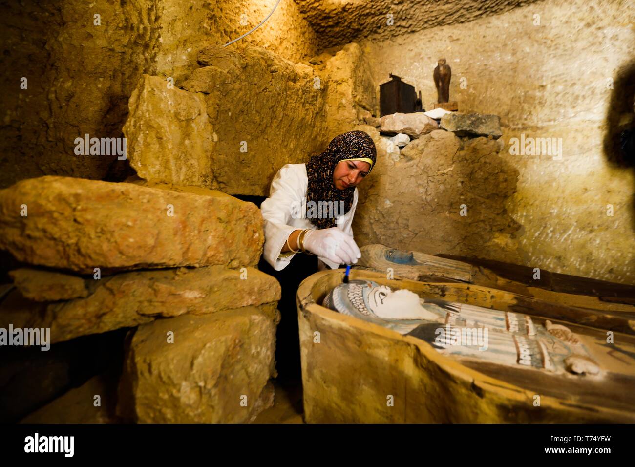 Giza, Egypt. 04th May, 2019. An Egyptian archaeological expert works on ...