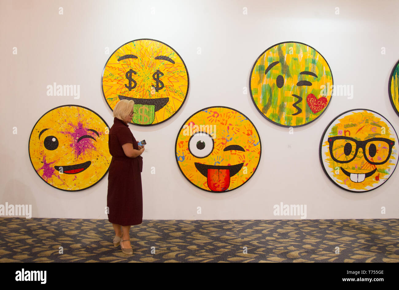 A visitor seen admiring Mochtar Sarman artwork during the Art Moments ...