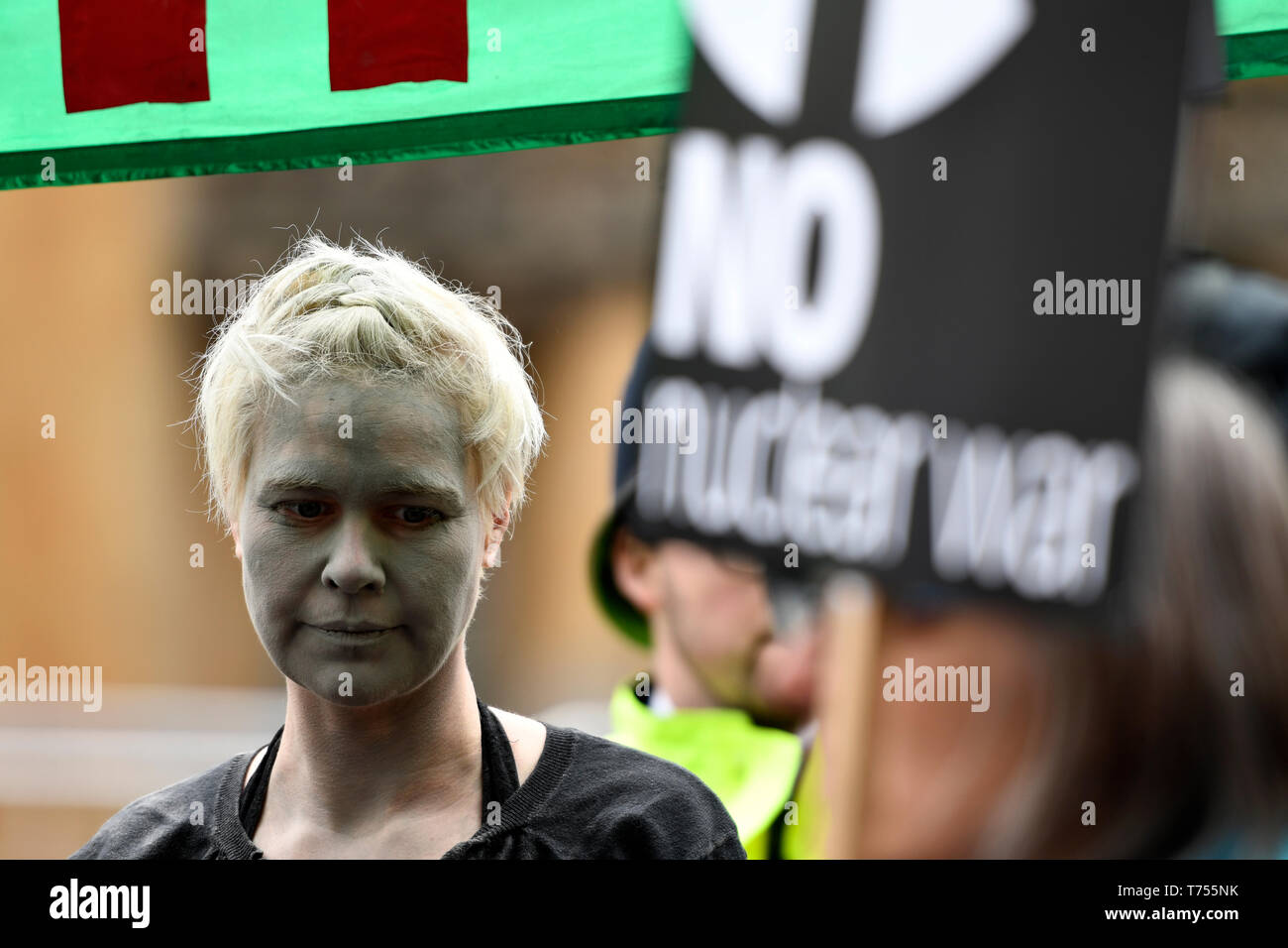 Activist is seen with her face covered with ash during the protest ...