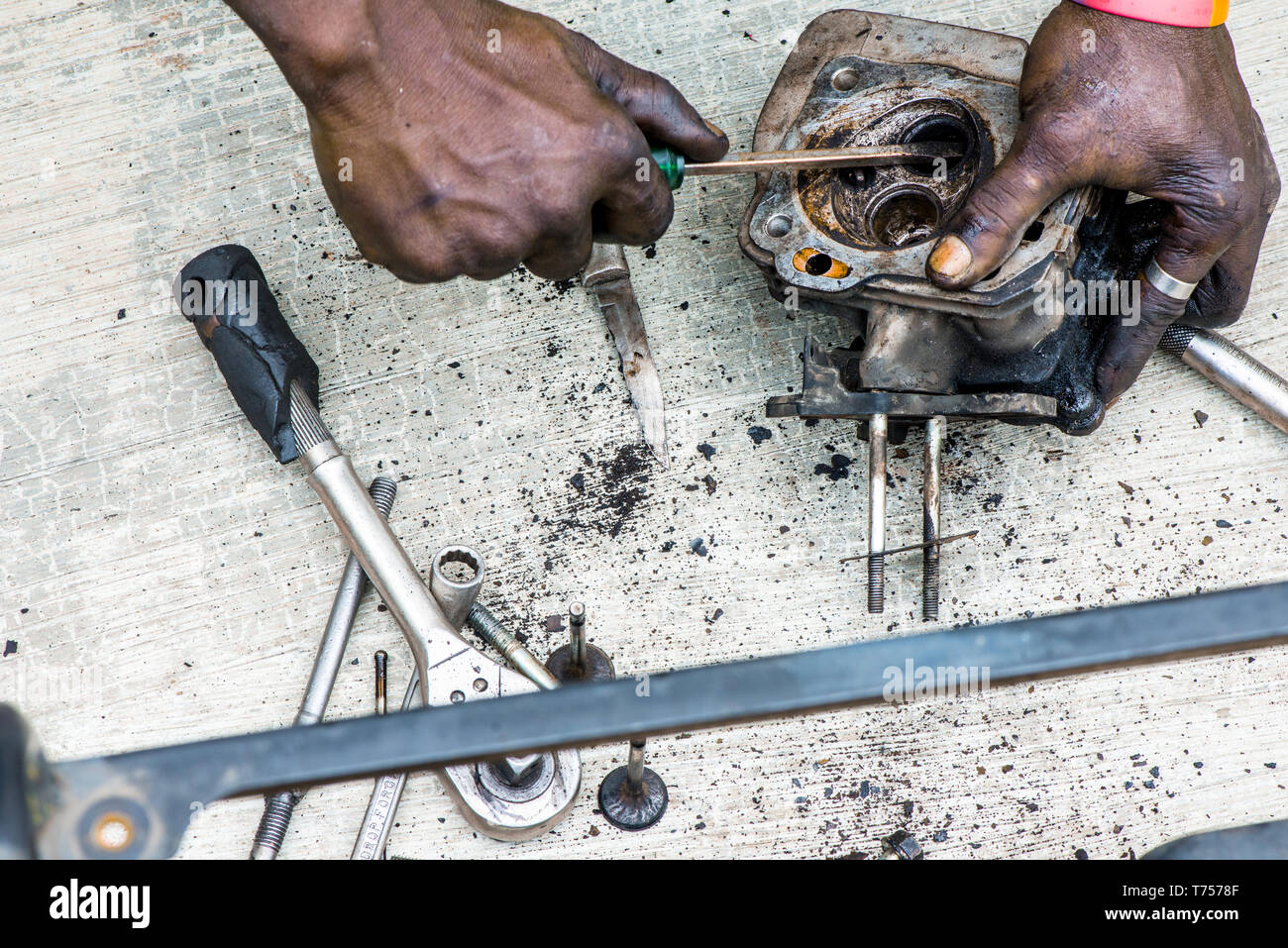 Black Hands working on different machine parts Stock Photo - Alamy