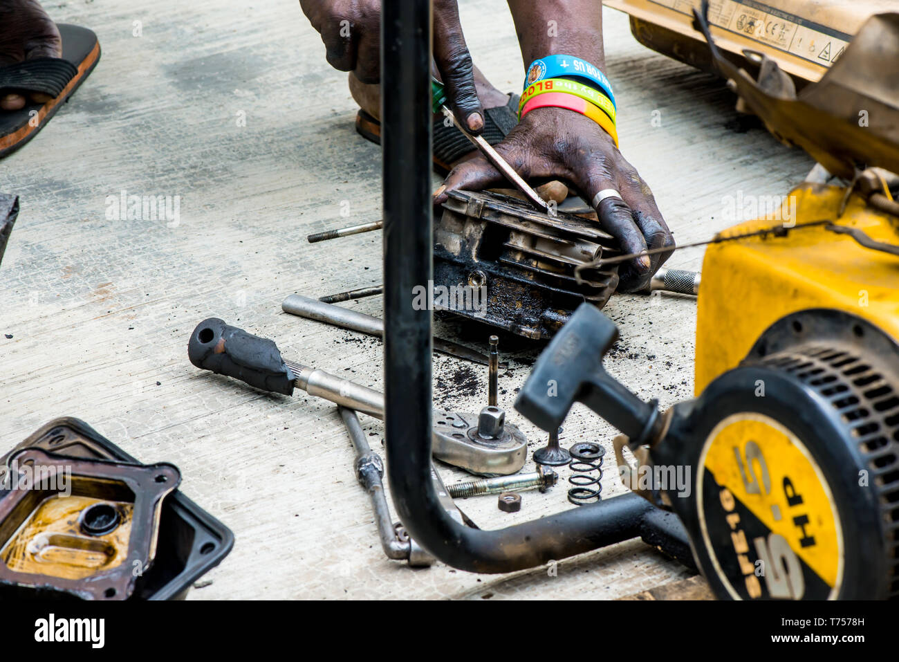 Black Hands working on different machine parts Stock Photo - Alamy