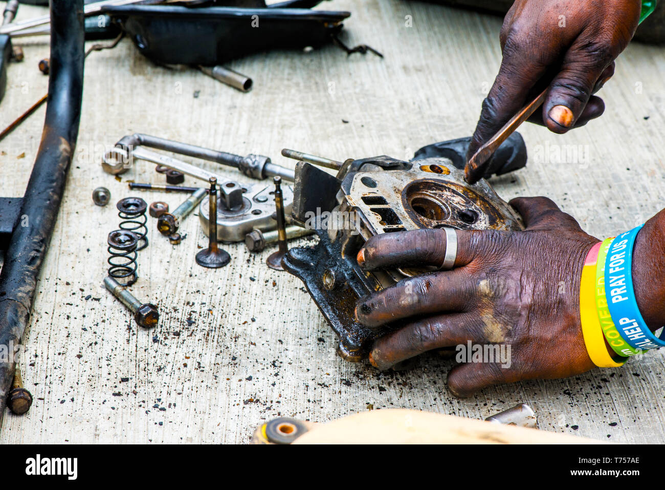 Black Hands working on different machine parts Stock Photo - Alamy