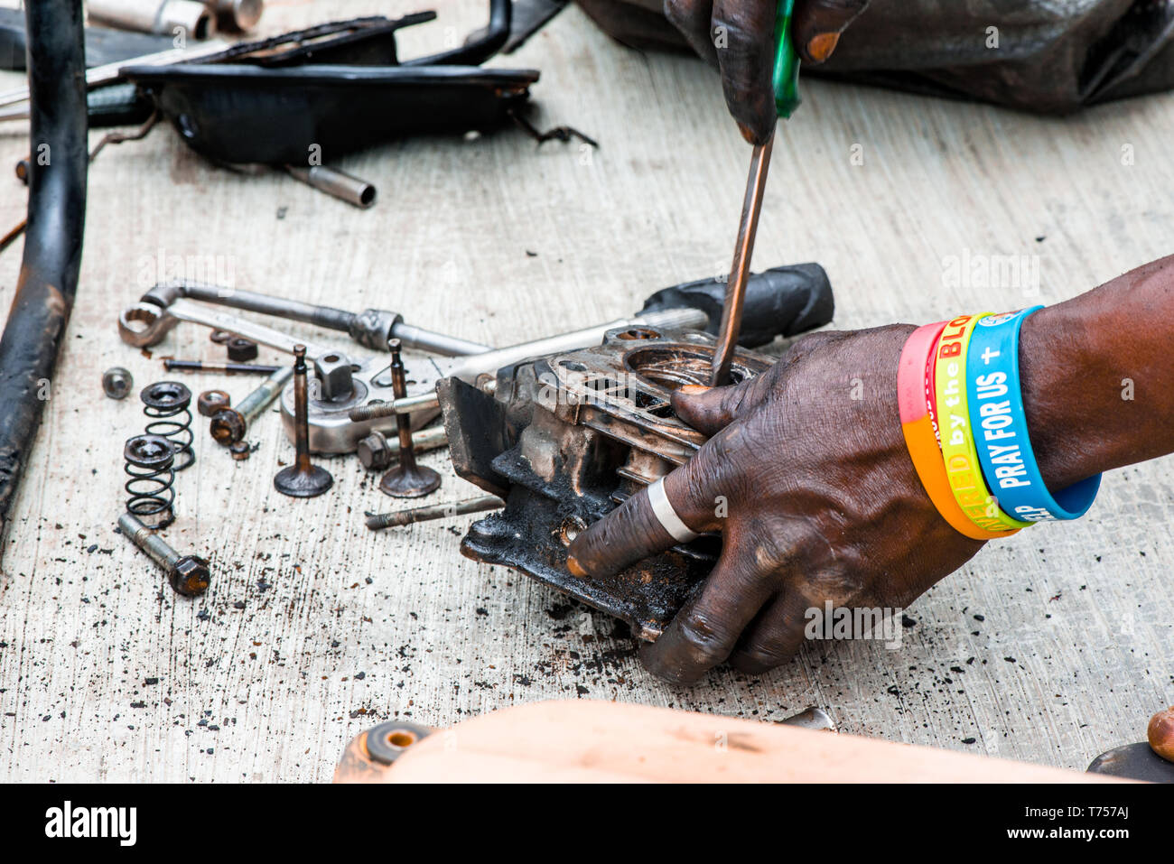 Black Hands working on different machine parts Stock Photo - Alamy