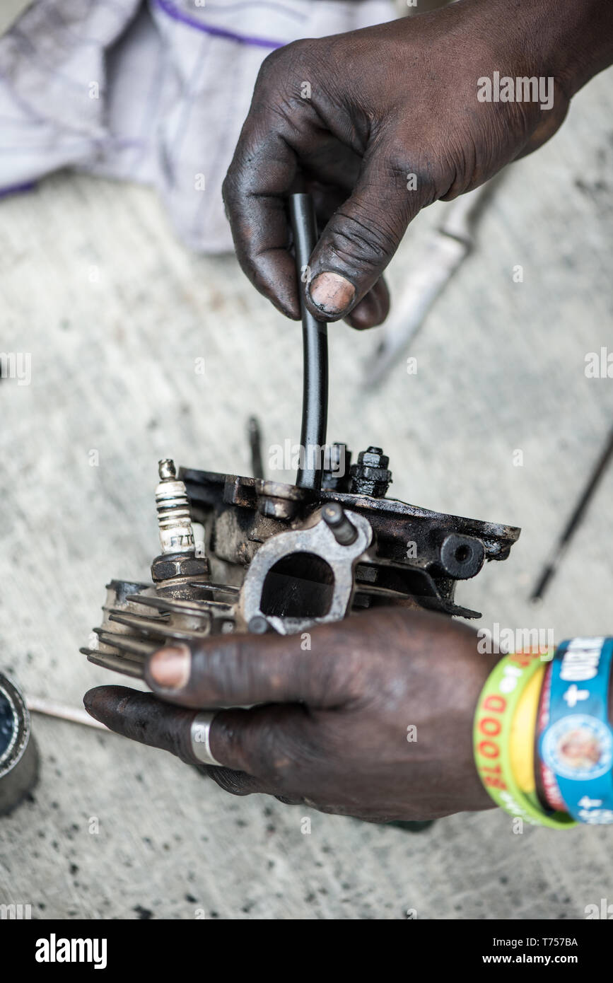 Black Hands working on different machine parts Stock Photo - Alamy