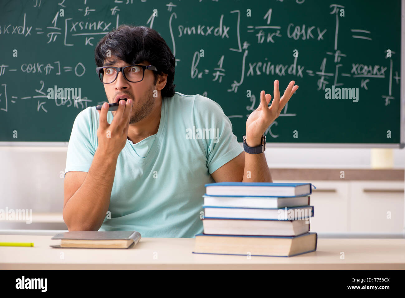 Young male student mathematician in front of chalkboard Stock Photo - Alamy