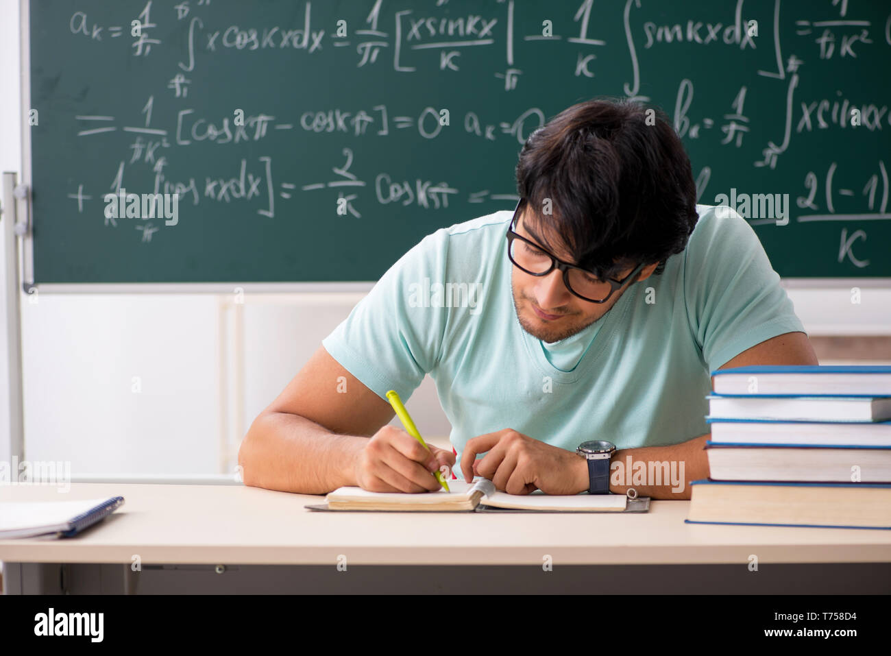 Young male student mathematician in front of chalkboard Stock Photo - Alamy