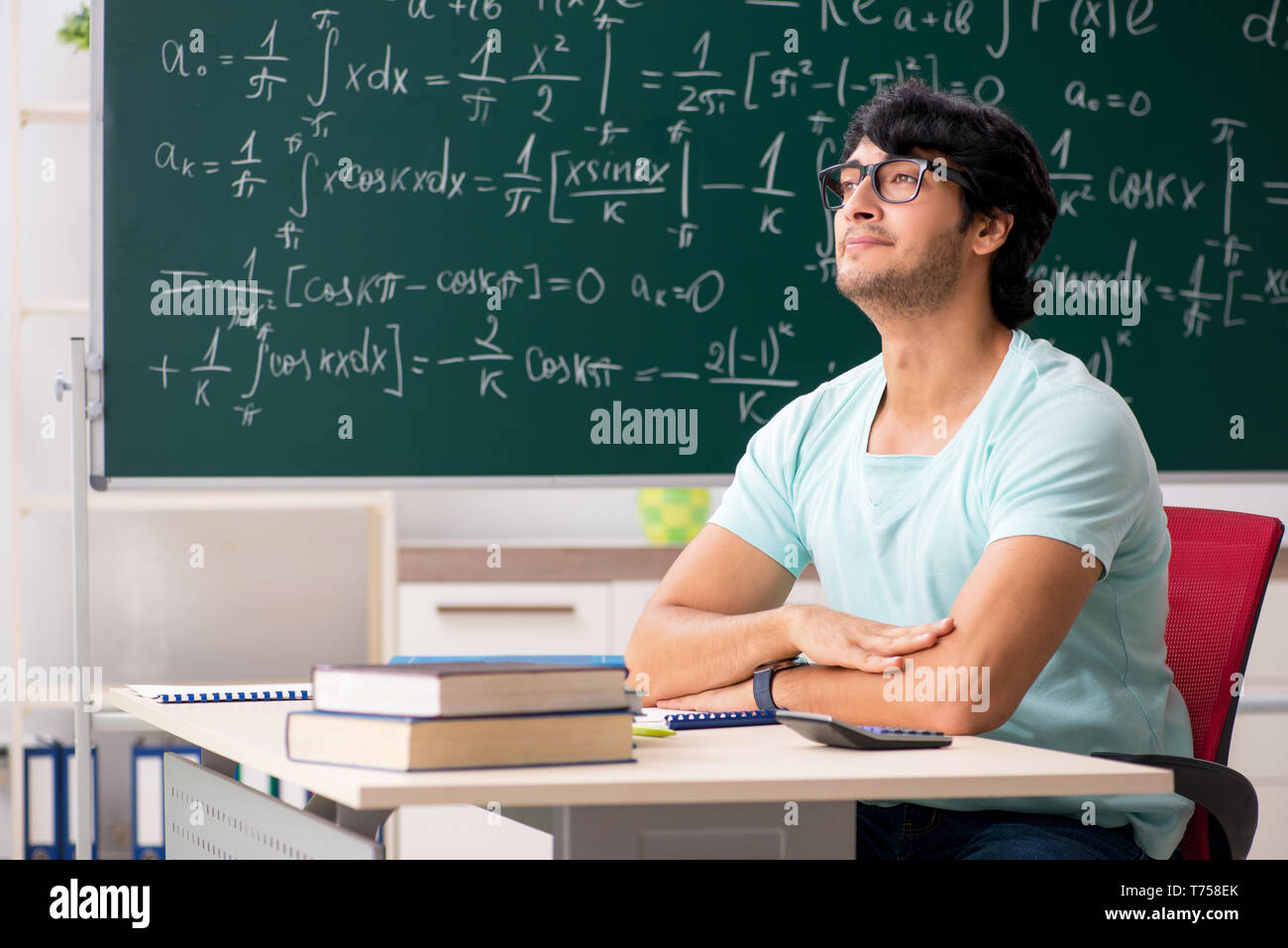 Young male student mathematician in front of chalkboard Stock Photo - Alamy