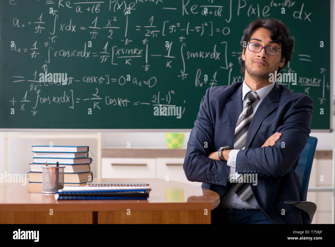 Young male math teacher in classroom Stock Photo - Alamy