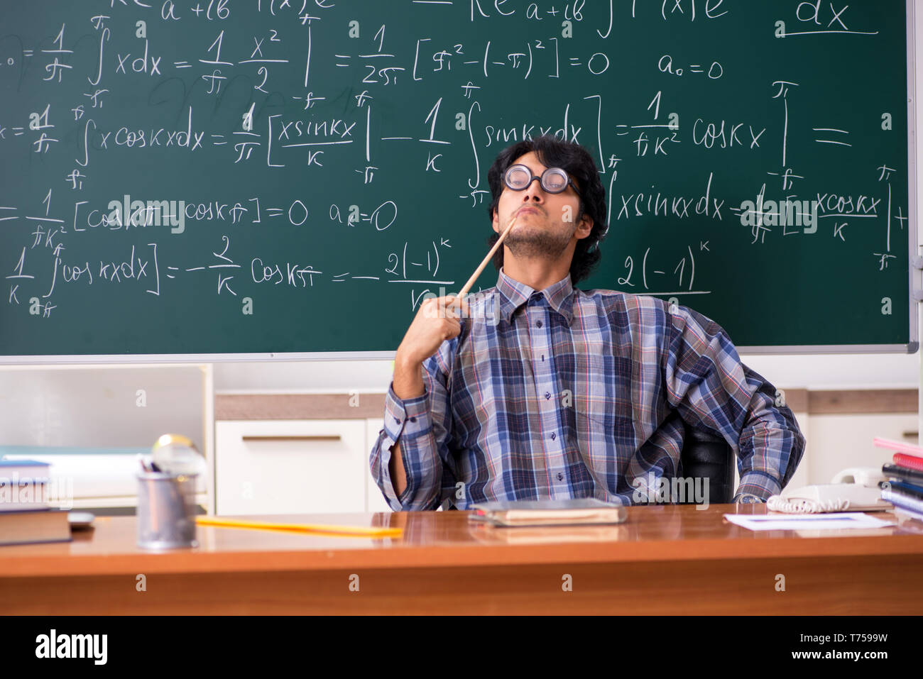 Funny male math teacher in the classroom Stock Photo - Alamy