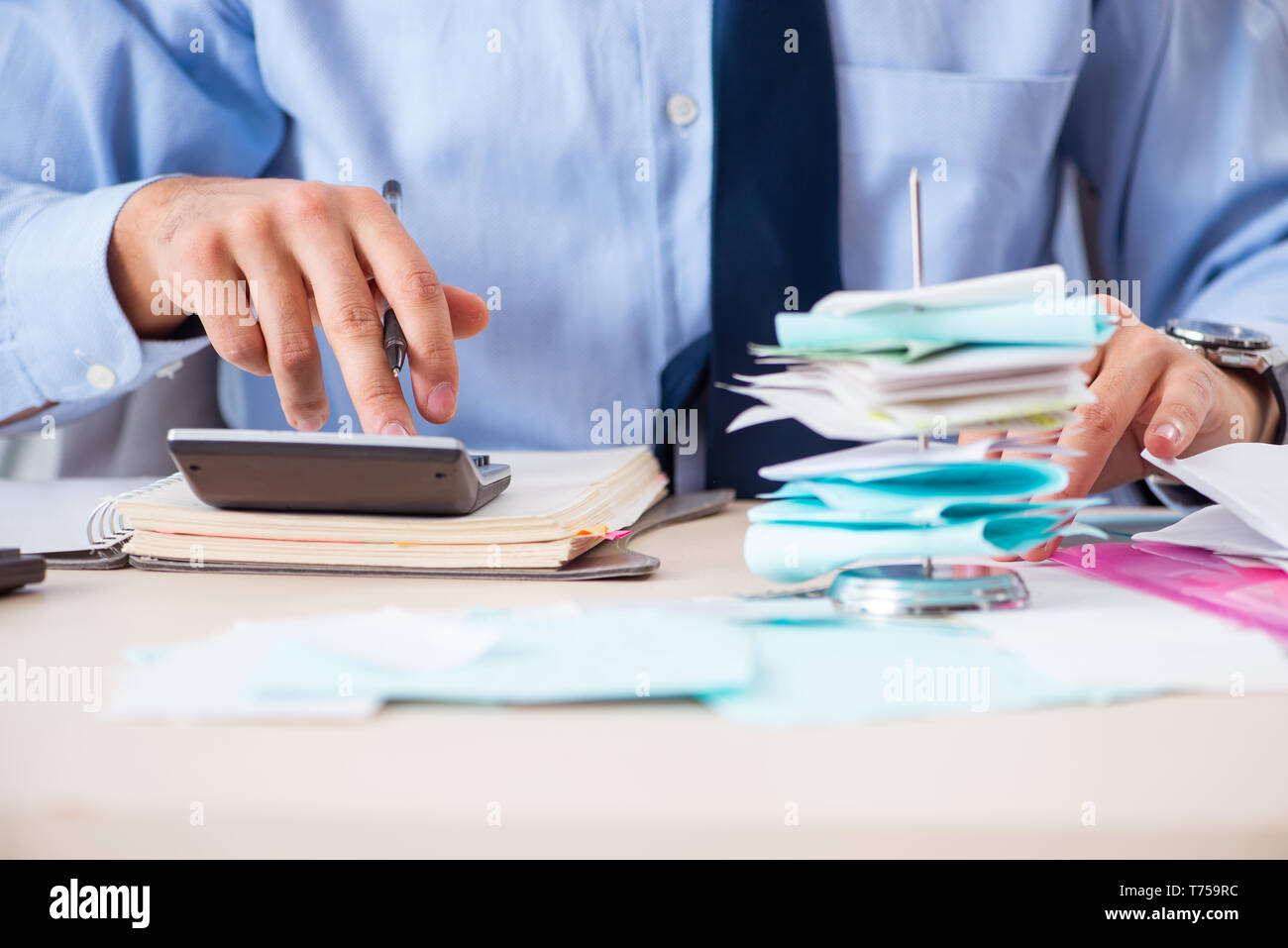 Young handsome businessman in budget planning concept Stock Photo - Alamy
