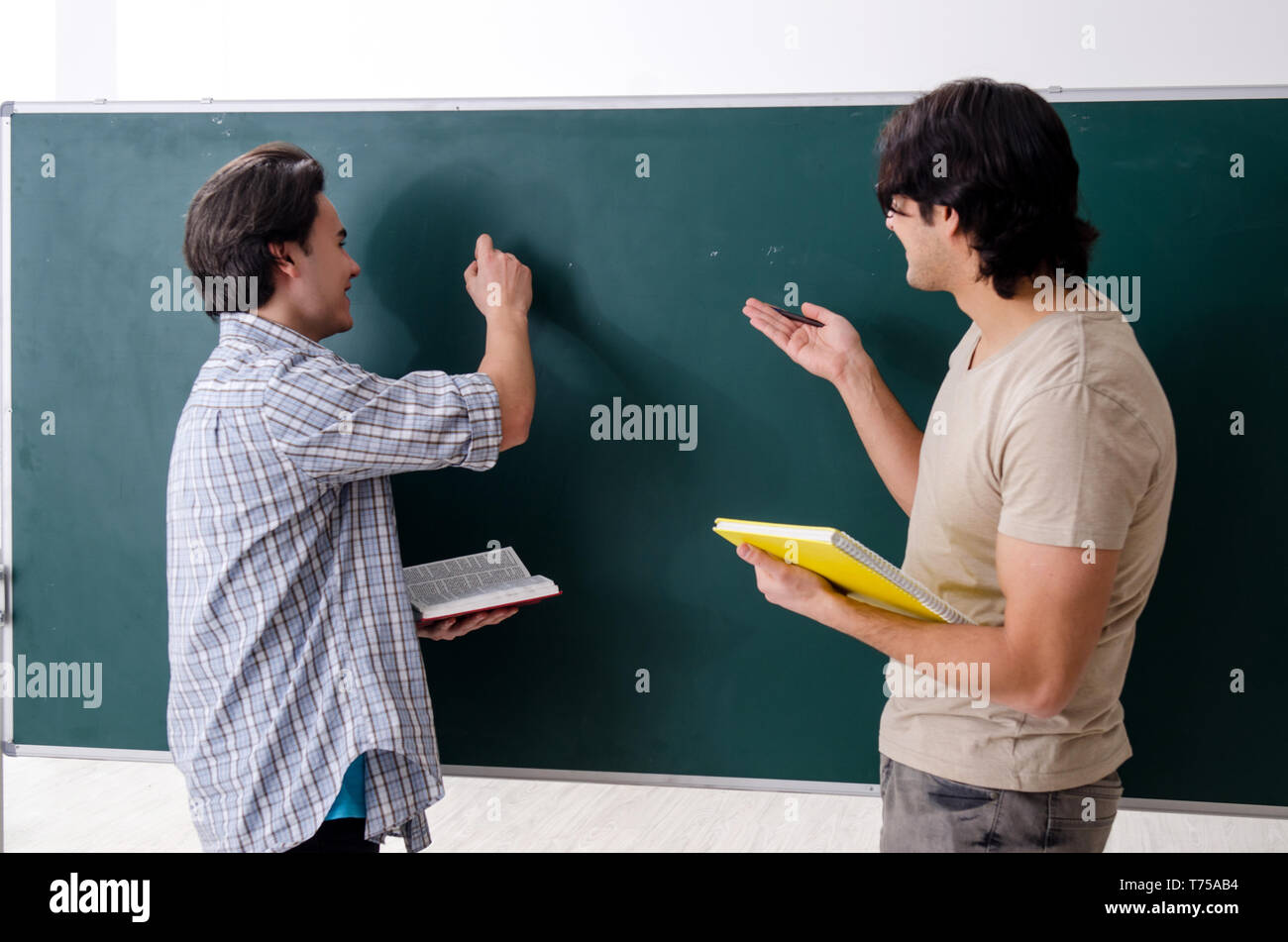Two male students in the classroom Stock Photo - Alamy