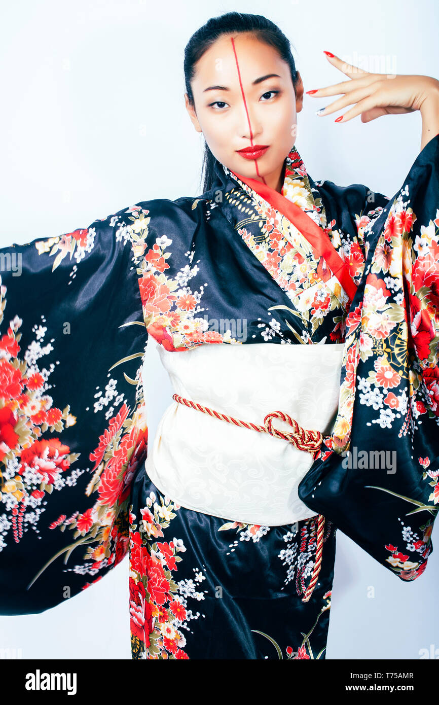 young pretty real geisha in kimono with sakura and decoration on white ...