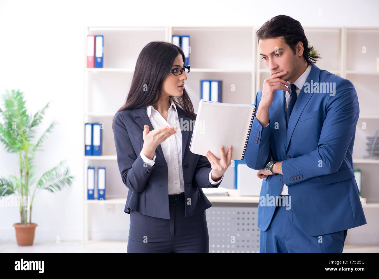 Two employees working in the office Stock Photo - Alamy