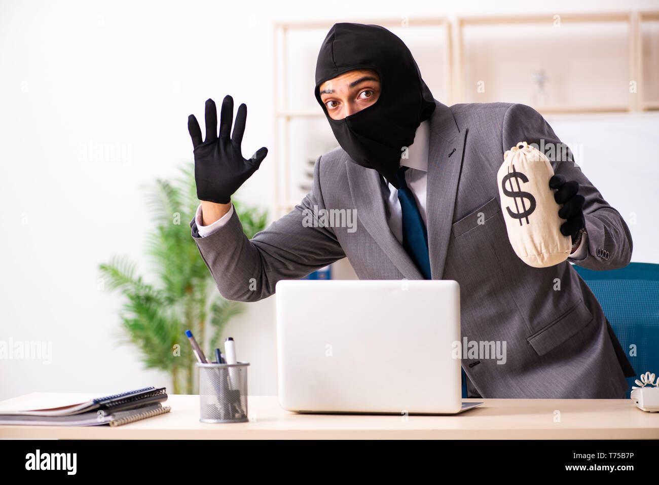 Male gangster stealing information from the office Stock Photo - Alamy