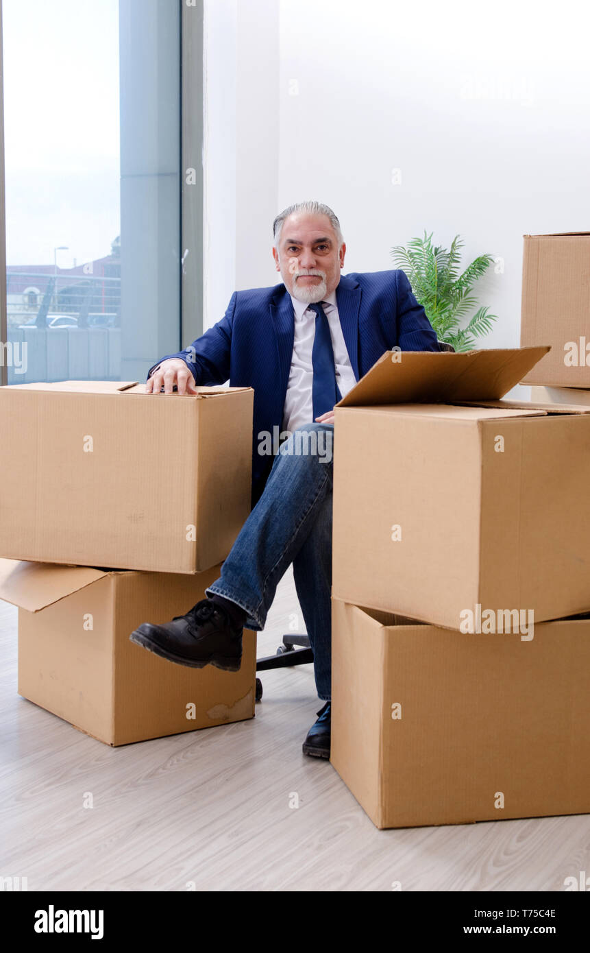 Aged businessman moving to new workplace Stock Photo - Alamy