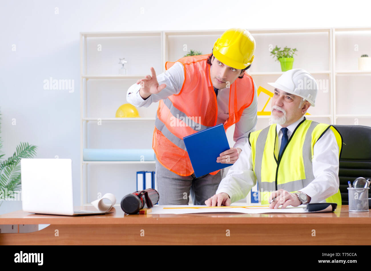 Two engineers colleagues working under project Stock Photo - Alamy