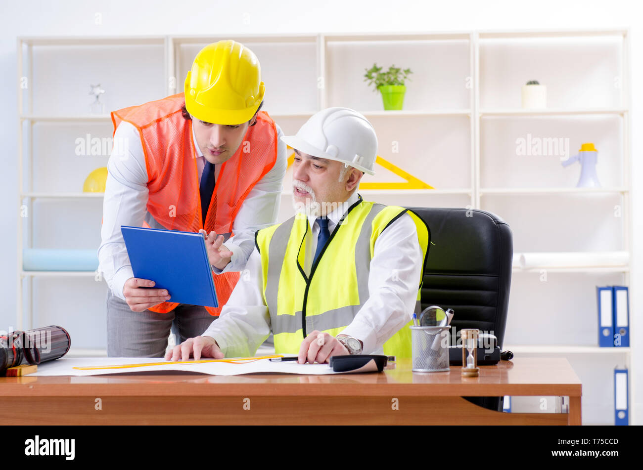 Two engineers colleagues working under project Stock Photo - Alamy