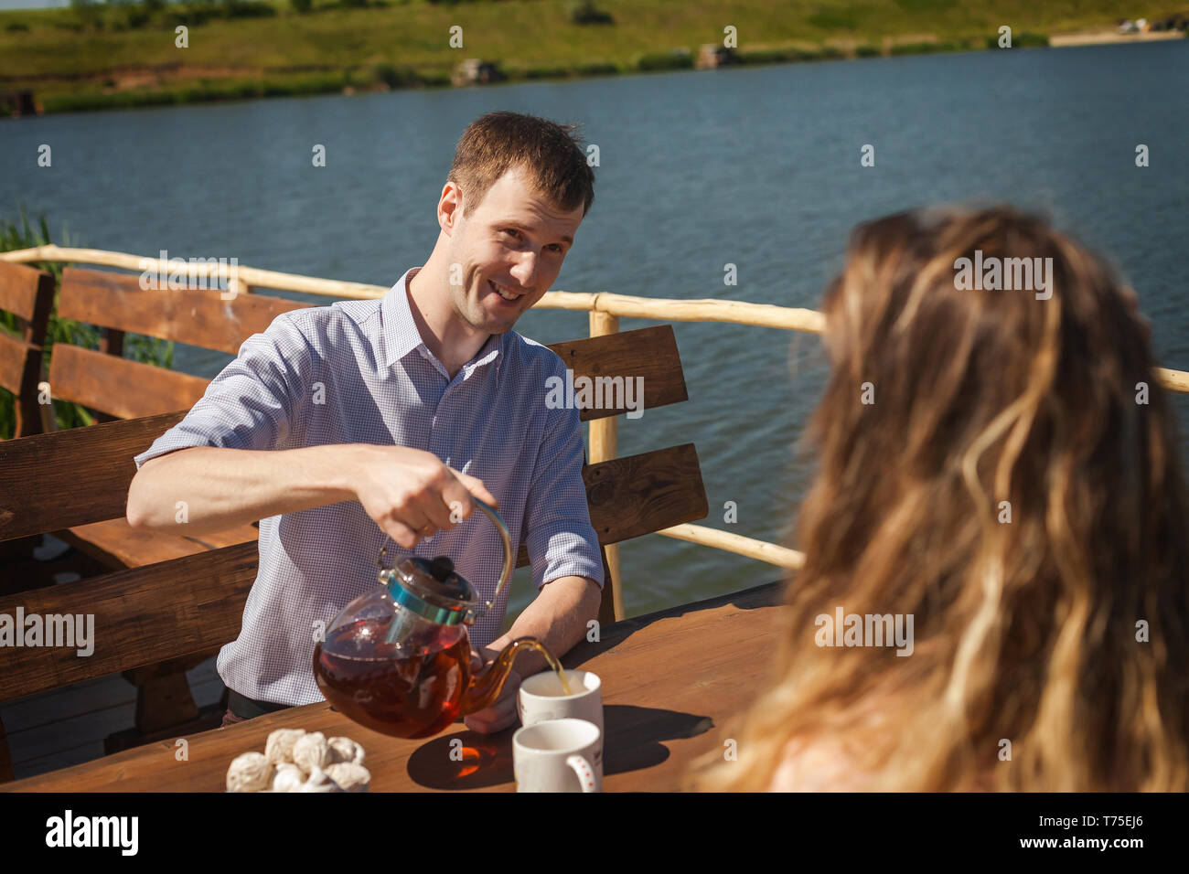 lovely couple drinking tea near lake Stock Photo - Alamy