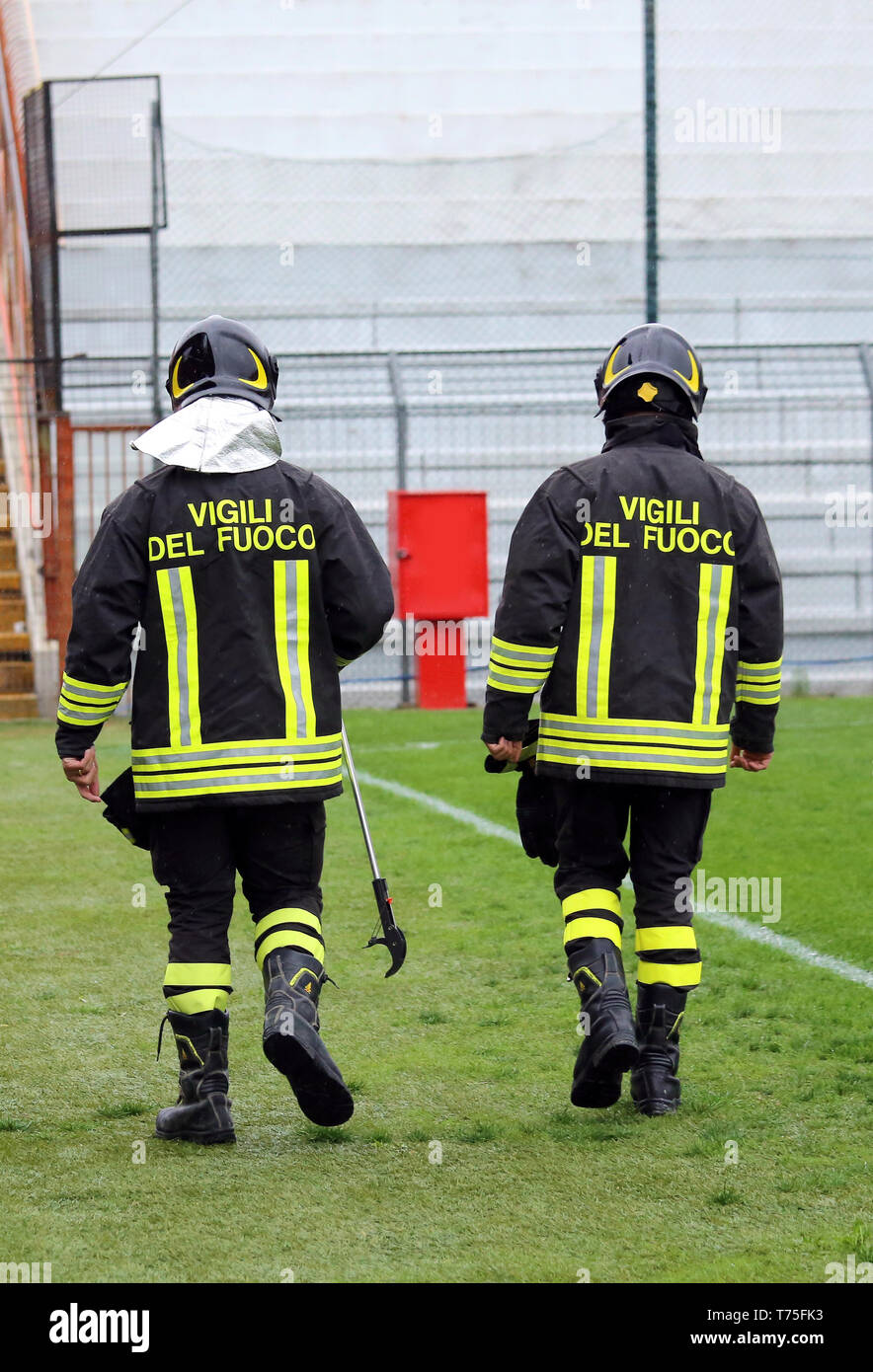 two Italian firefighters with uniform with the text Vigili del fuoco ...