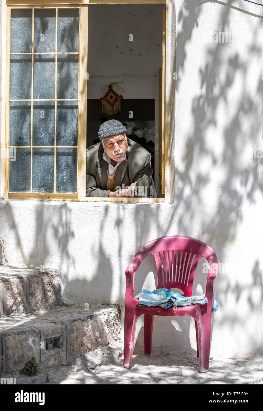 kashan, Iran, 25th April 2019: iranian man looking out of his window in ...