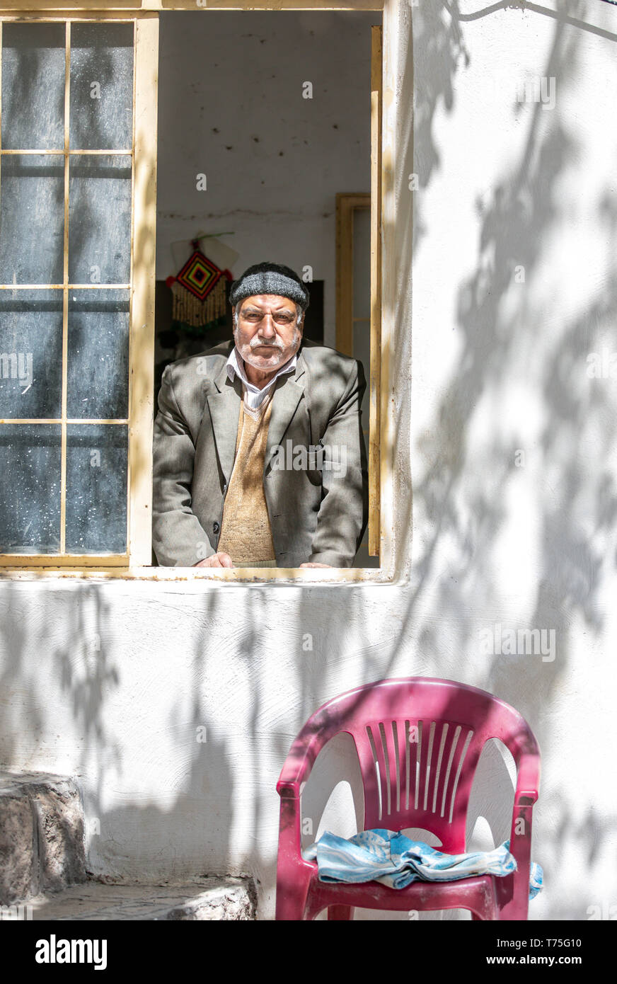 kashan, Iran, 25th April 2019: iranian man looking out of his window in ...