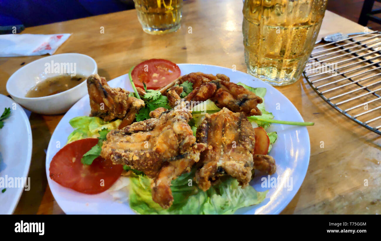Crispy deep fried frog meat with legs crumbled battered sauce with ...