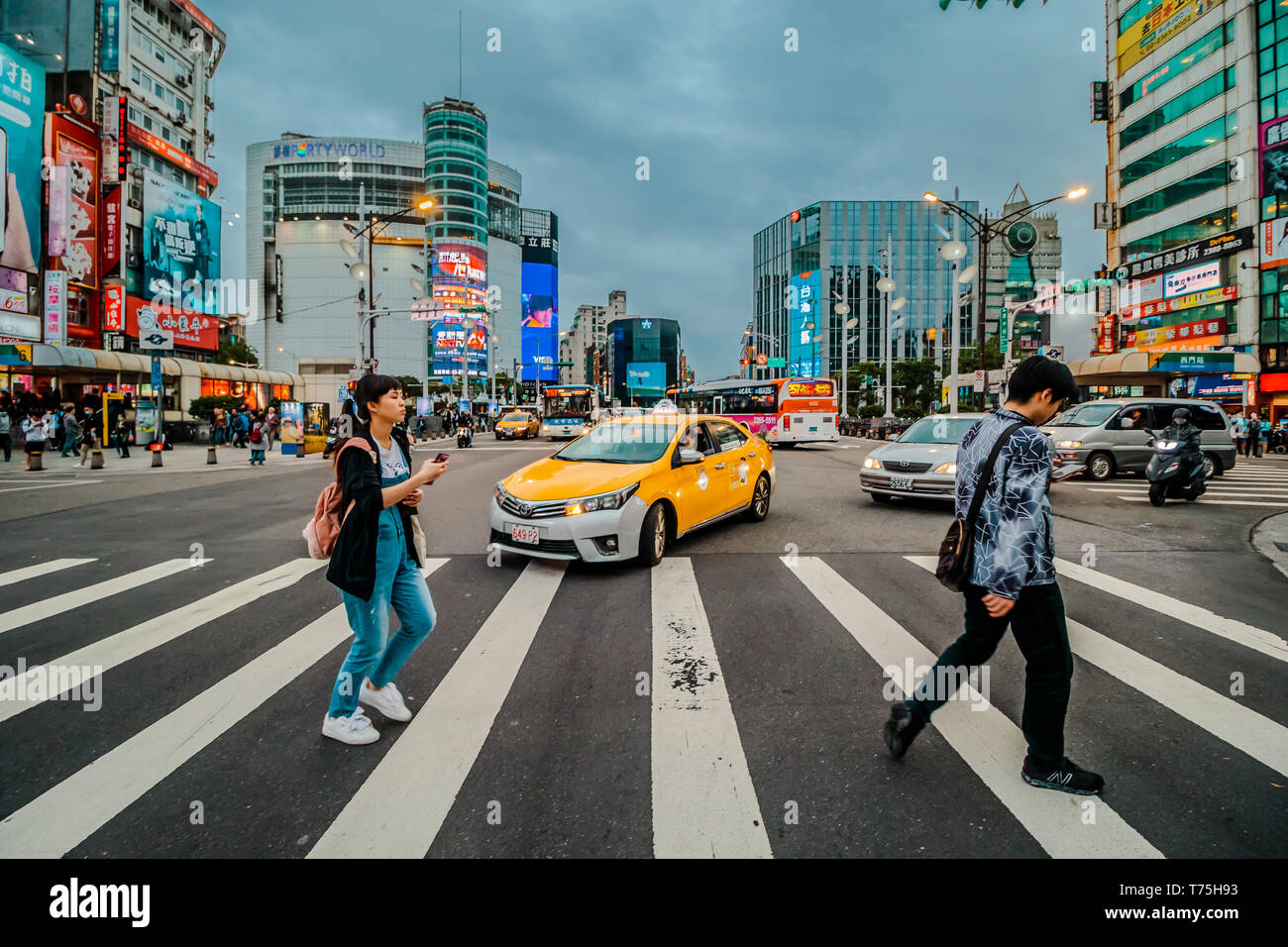 People crossing the crossroad in front of Ximending Shopping district ...