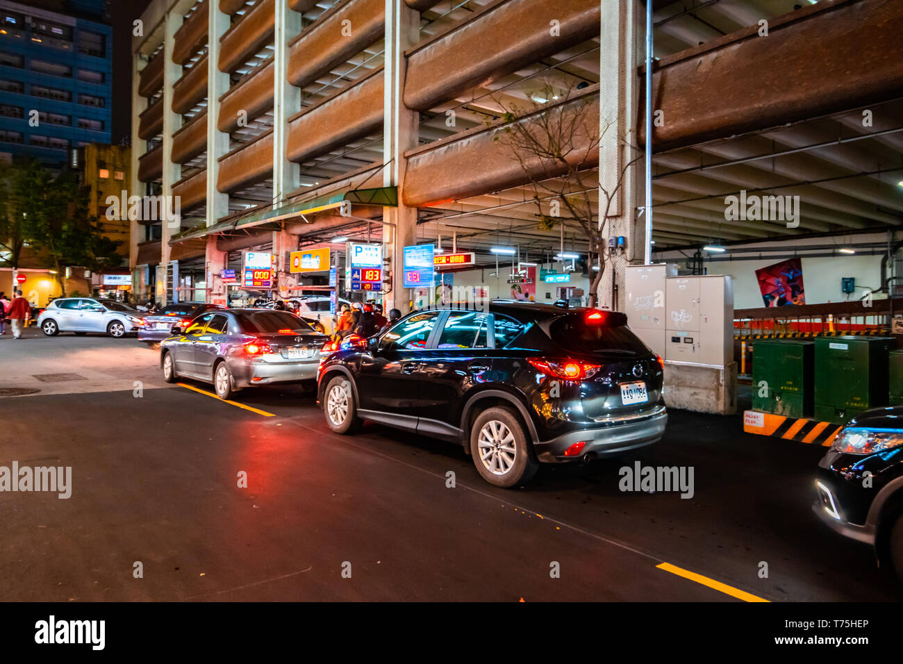 Cars in queue and waiting in front of a parking lots in Ximending ...