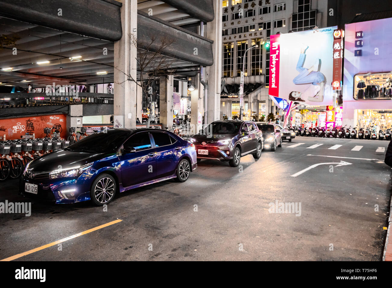 Cars in queue and waiting in front of a parking lots in Ximending ...