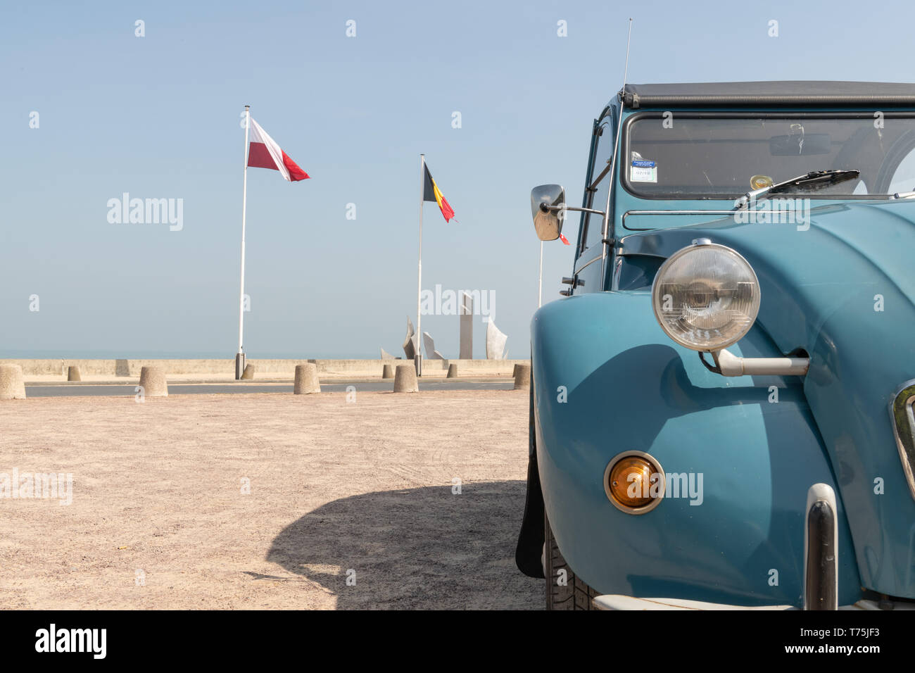 French vintage car in blue with French flag in the background. A cute ...