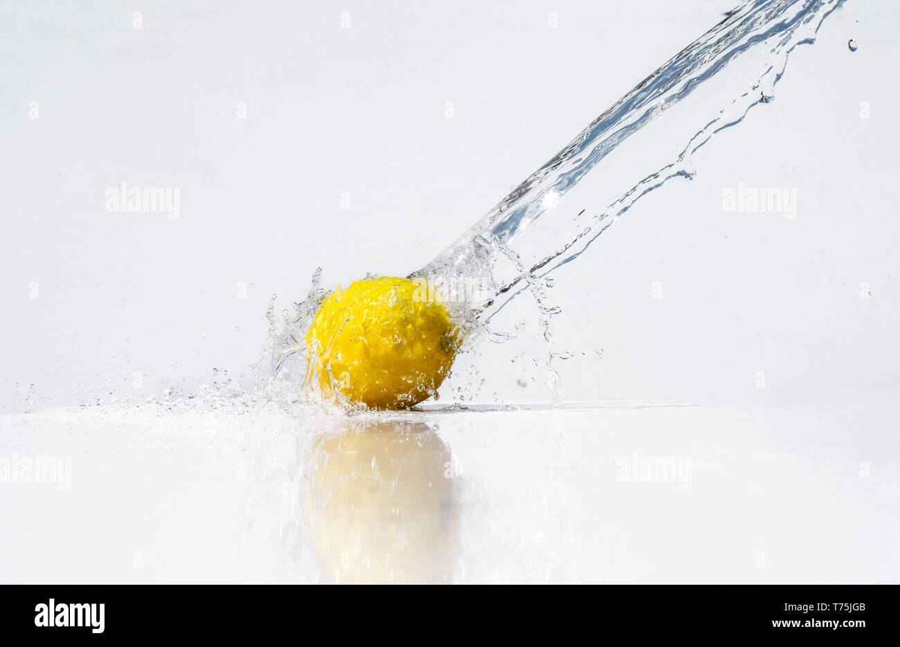 Yellow lemon in water splash on white background Stock Photo - Alamy