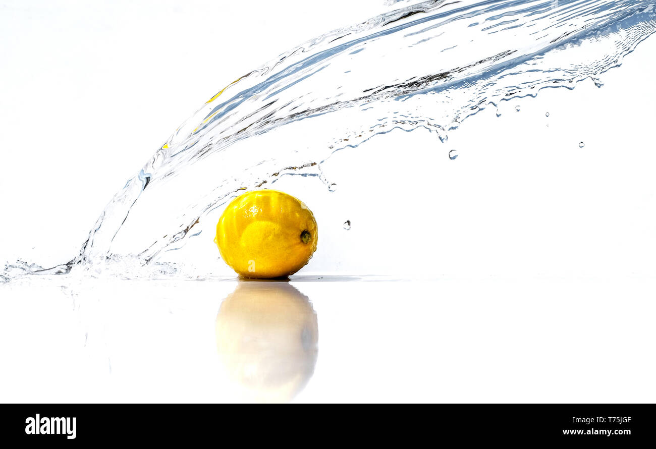 Yellow lemon in water splash on white background Stock Photo - Alamy
