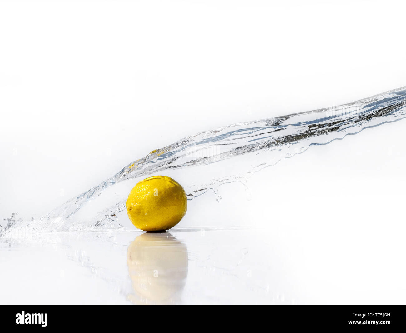 Yellow lemon in water splash on white background Stock Photo - Alamy