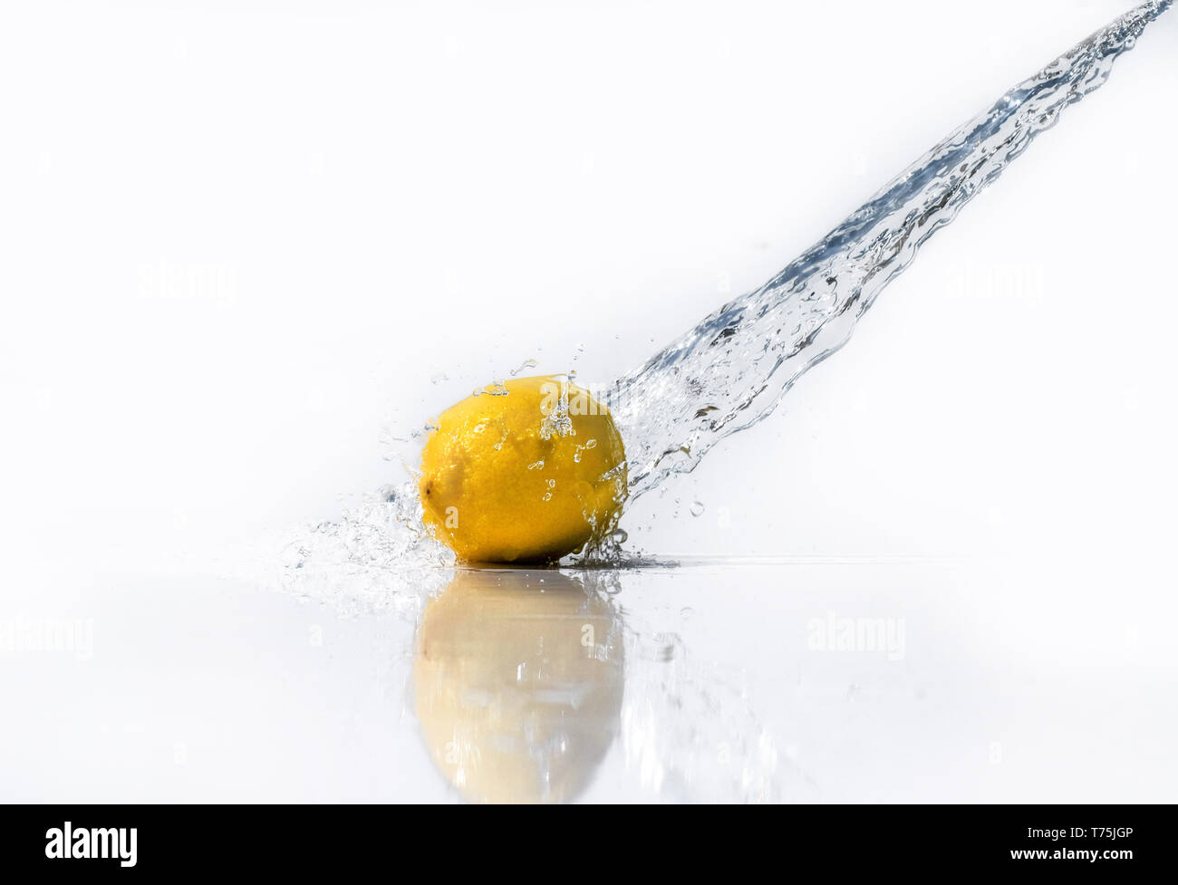 Yellow lemon in water splash on white background Stock Photo - Alamy