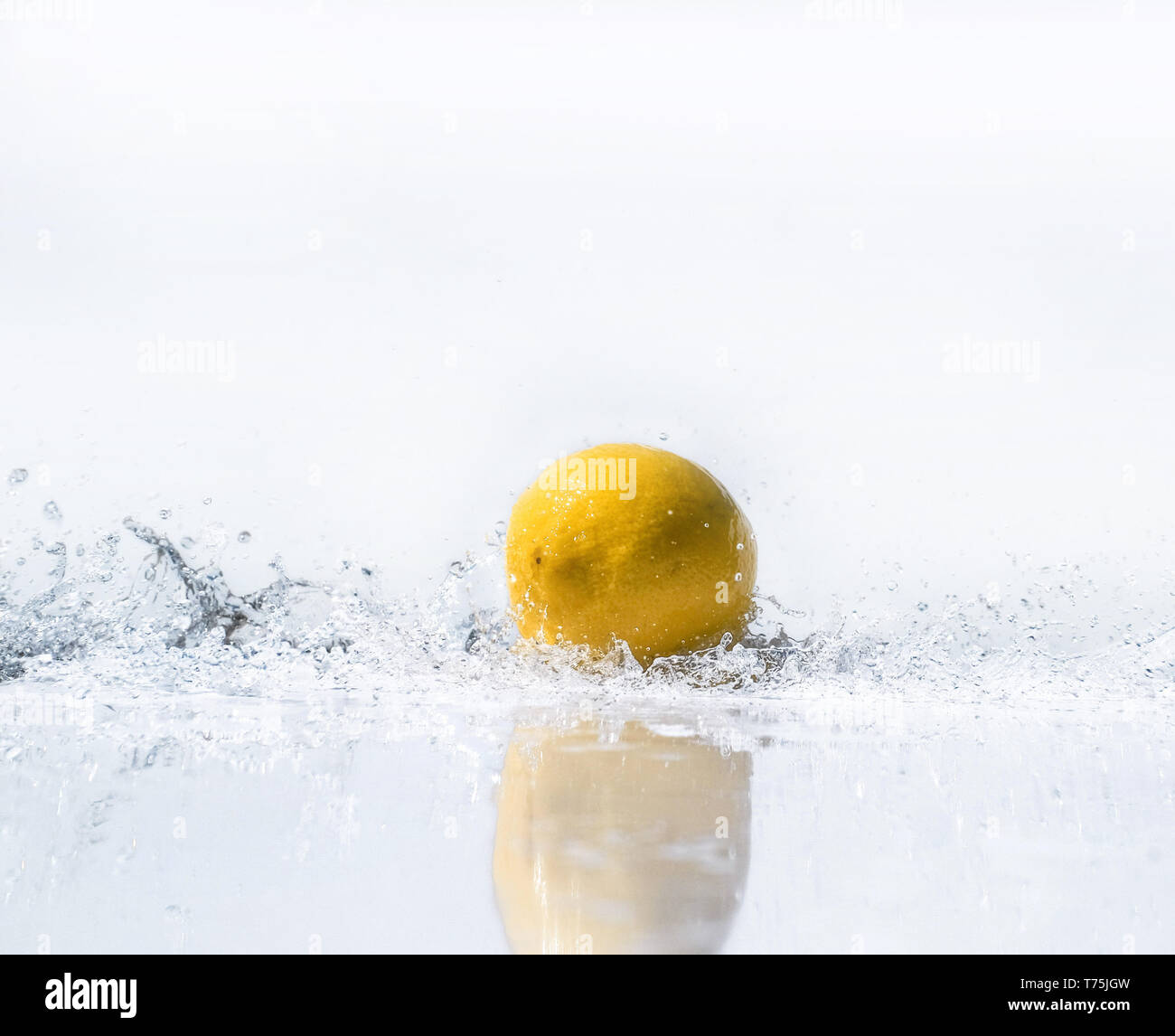 Yellow lemon in water splash on white background Stock Photo - Alamy