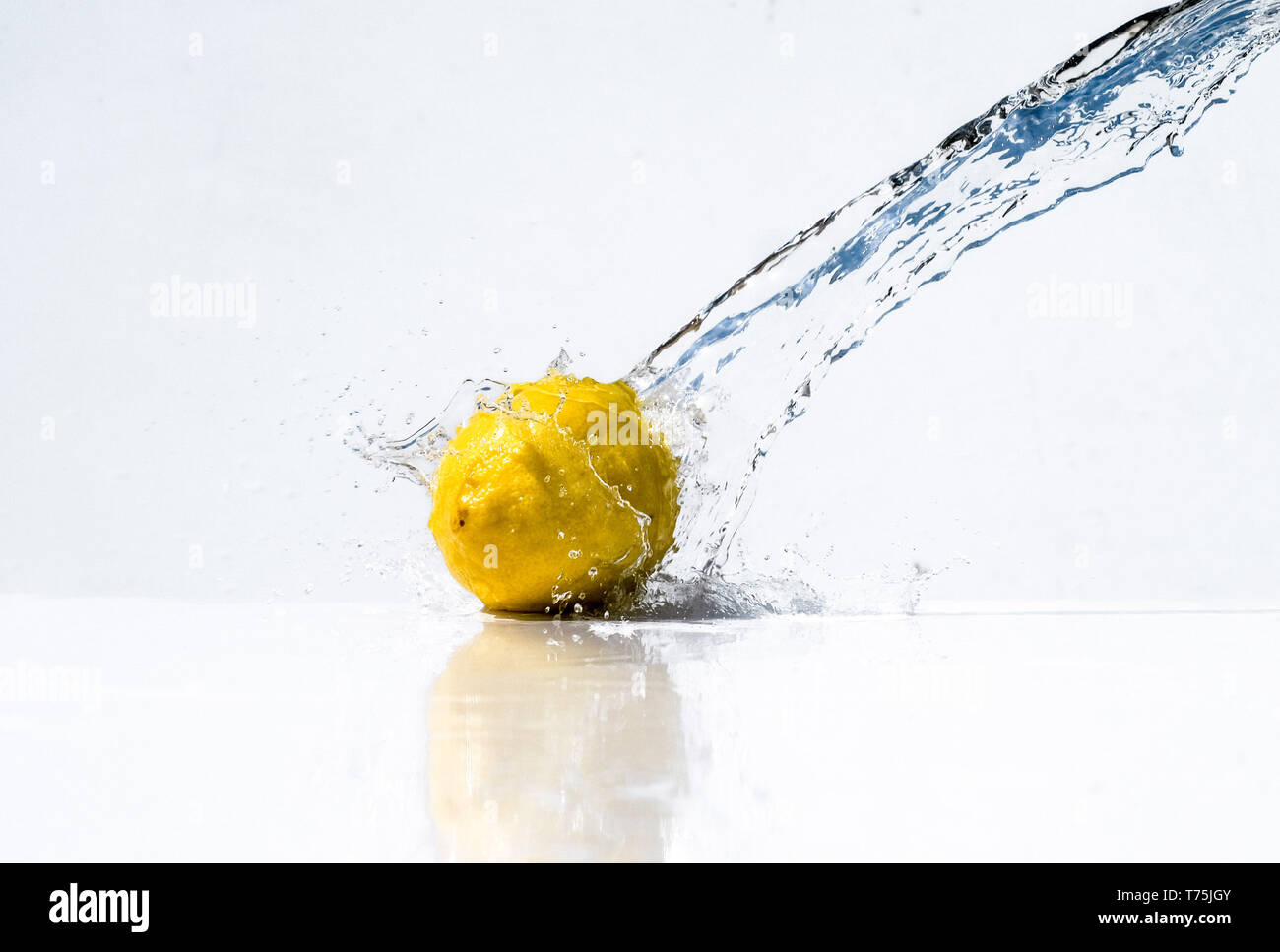 Yellow lemon in water splash on white background Stock Photo - Alamy