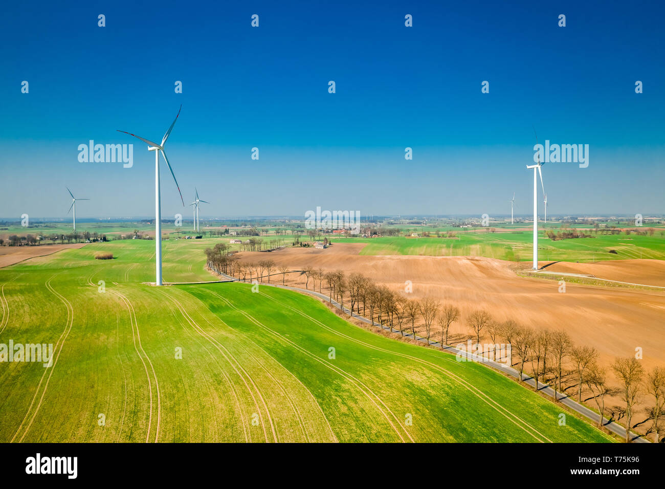 Flying above big wind turbines as alternative energy Stock Photo - Alamy