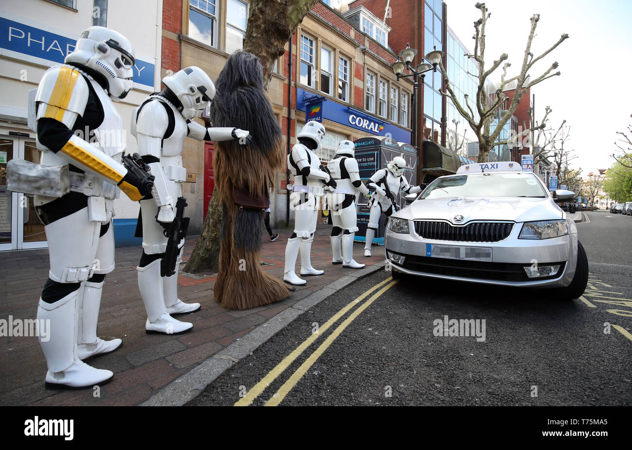 Cosplay actors dressed as Stormtroopers pose for a picture as they hail ...