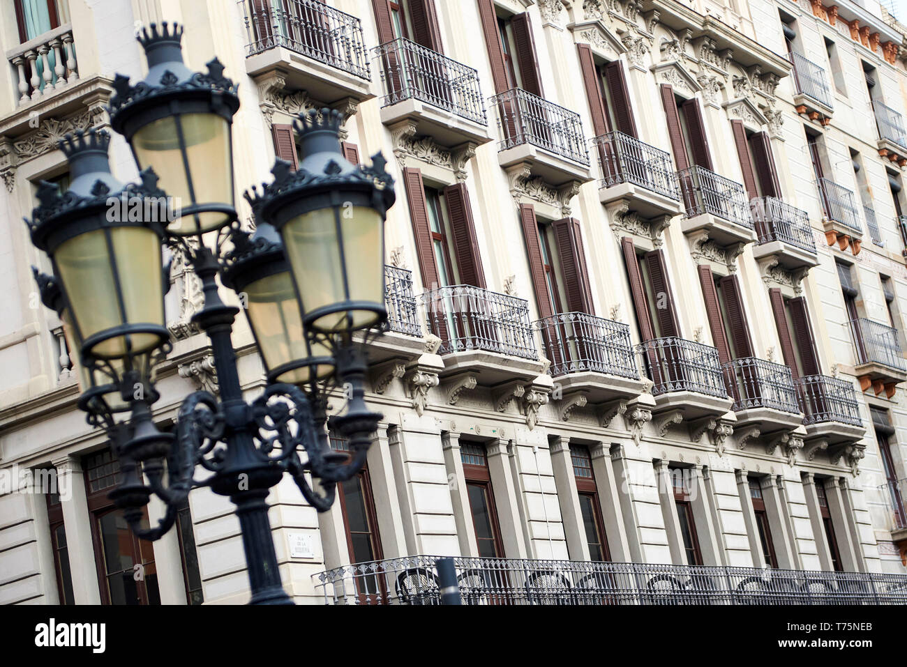 Street lights in front of Spanish architecture on La rambla, Barcelona ...