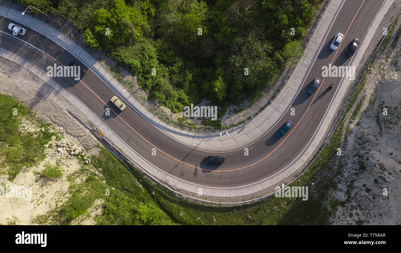 Aerial view of a curved winding road trough the mountains Stock Photo ...