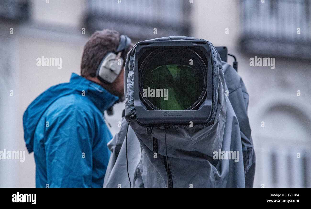Camera man with waterproofs and camera cover hi-res stock photography ...