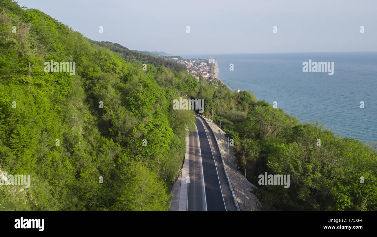 Aerial view over mountain road going through forest landscape, Winding ...